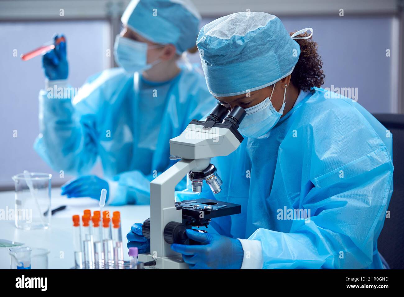 Female Lab Workers Wearing PPE Researching In Laboratory With ...