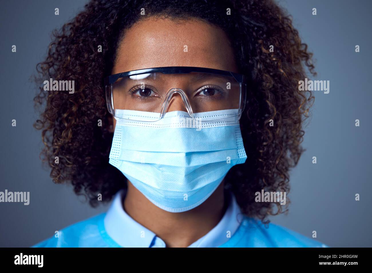 Studio Portrait Of Female Lab Worker in PPE With Face Mask And Safety ...