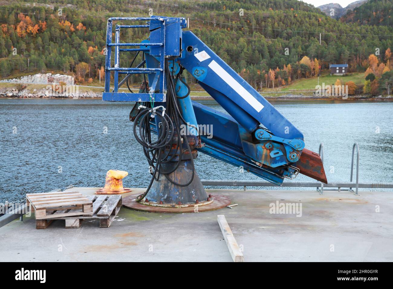 Small blue port crane mounted on pier in Norwegian port Stock Photo - Alamy