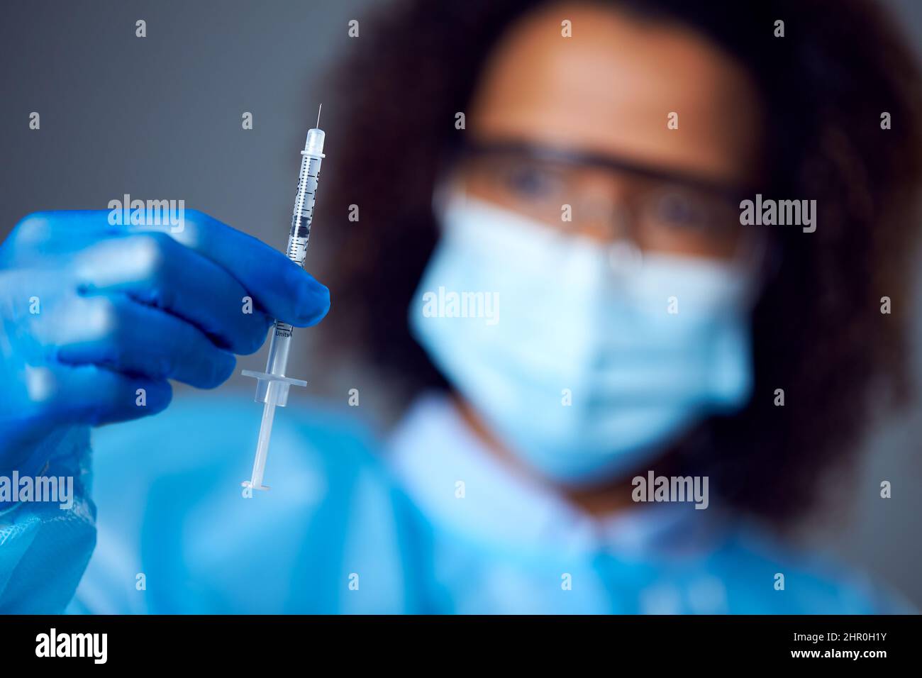 Female Lab Research Worker Wearing PPE Holding Syringe For Vaccination ...