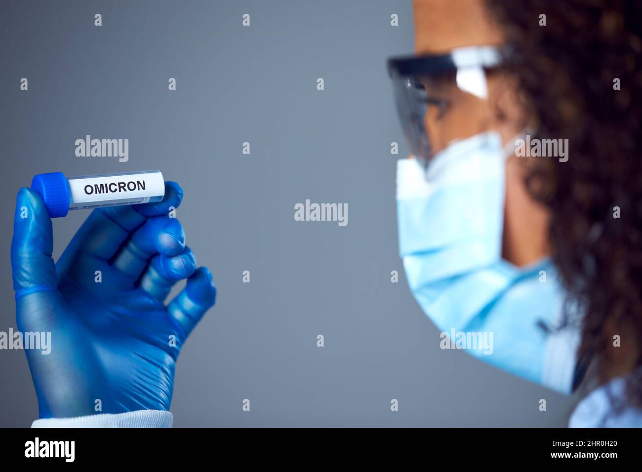 Female Lab Research Worker Wearing PPE Holding Test Tube Labelled ...