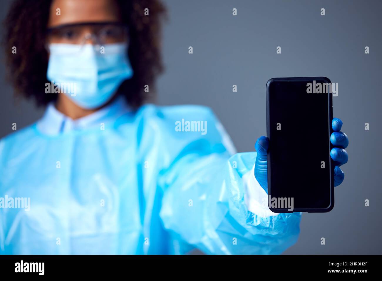 Studio Portrait Of Female Lab Worker in PPE With Face Mask And Safety ...