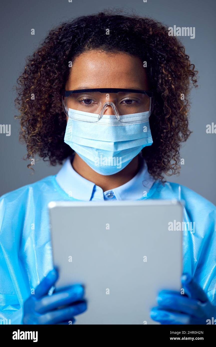 Studio Portrait Of Female Lab Worker in PPE With Face Mask And Safety ...