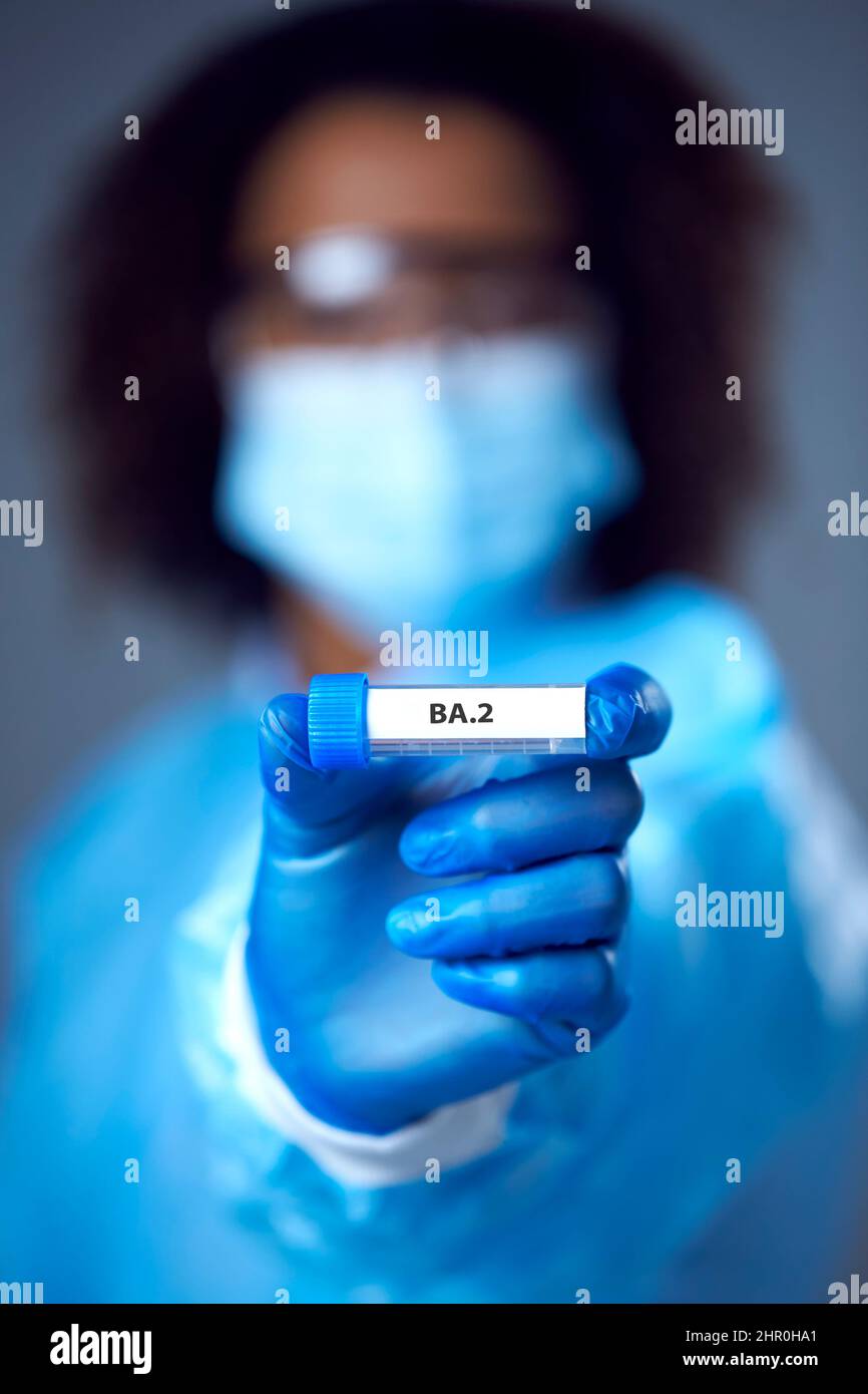 Studio Portrait of Female Lab Research Worker Wearing PPE Holding Test ...