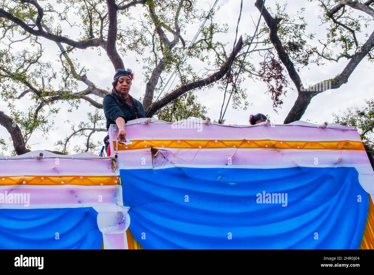 NEW ORLEANS, LA, USA - FEBRUARY 20, 2022: Woman throwing beads from ...