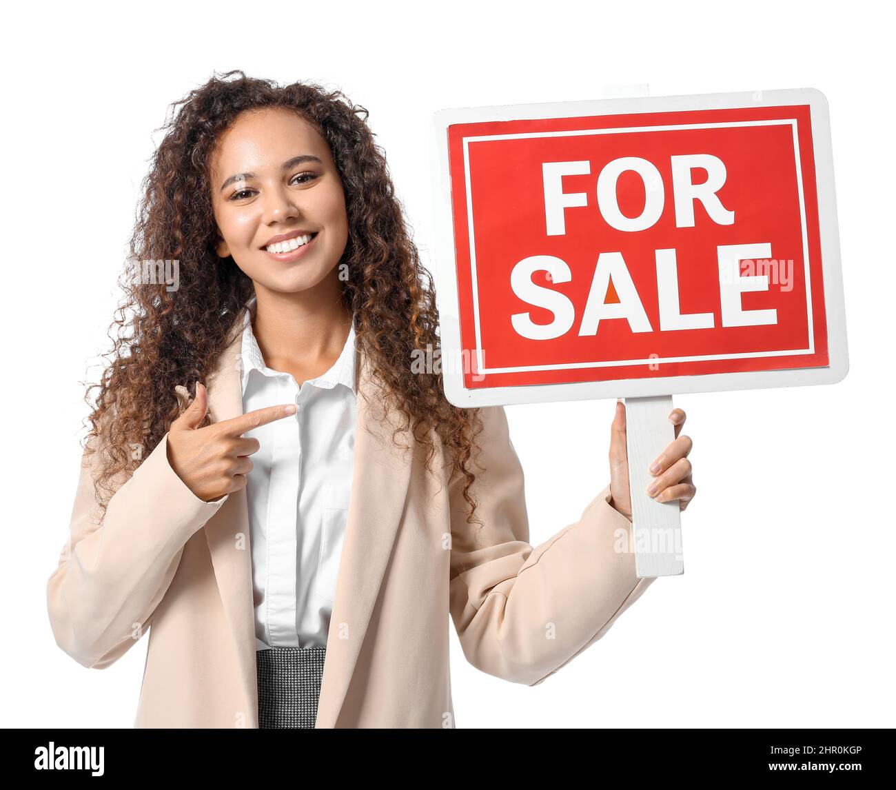 African-American real estate agent with "For Sale" sign on white ...