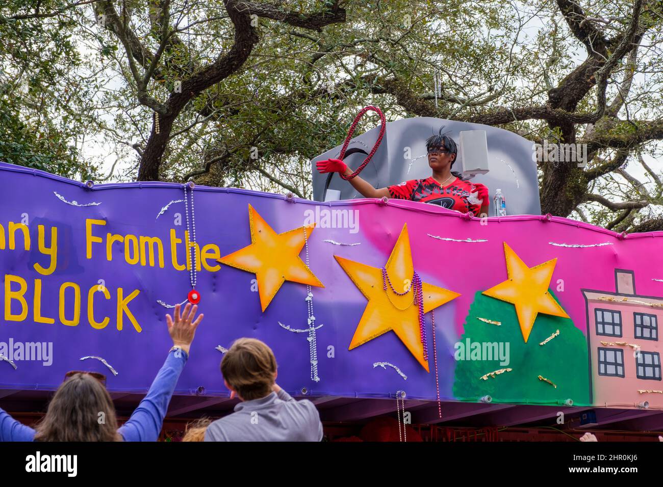 NEW ORLEANS, LA, USA - FEBRUARY 20, 2022: Float rider twirling beads on ...