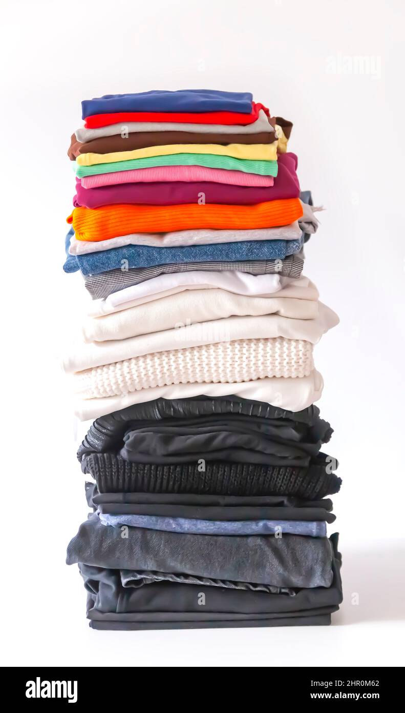 Folded colorful clothes in a stack. Home organizing. Domestic storage ...
