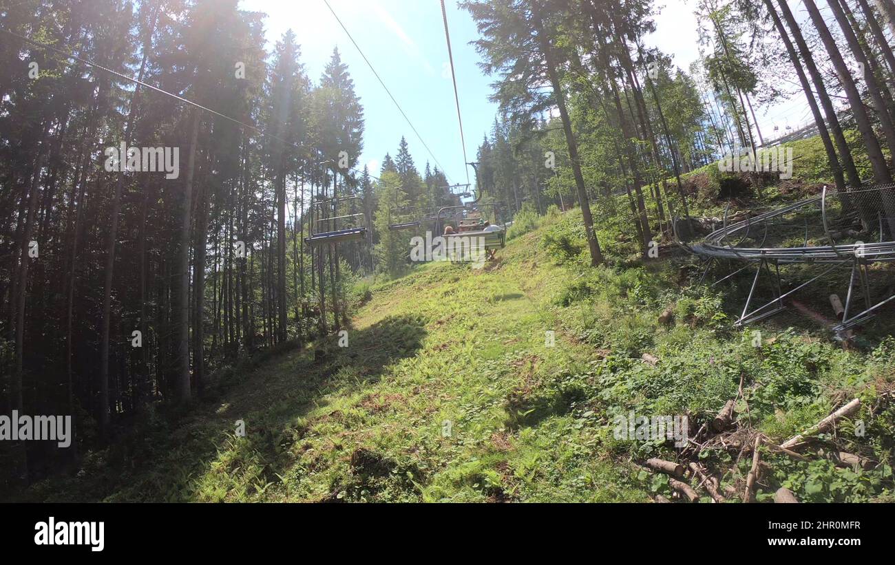 Ropeway with people movement in forest in mountains on sunny day Stock ...