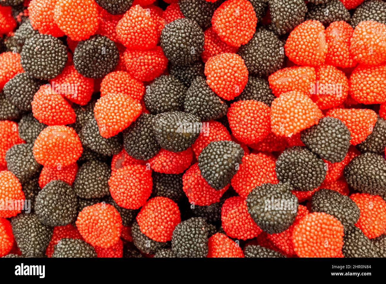Pile of sweet candies in the shape of raspberries and blackberries ...