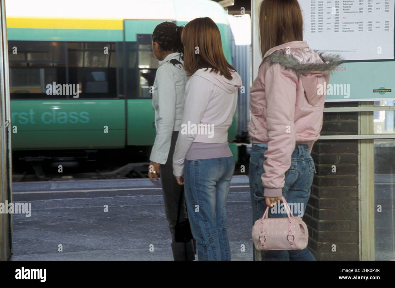 three teenage girls waiting on station platform, UK Stock Photo - Alamy
