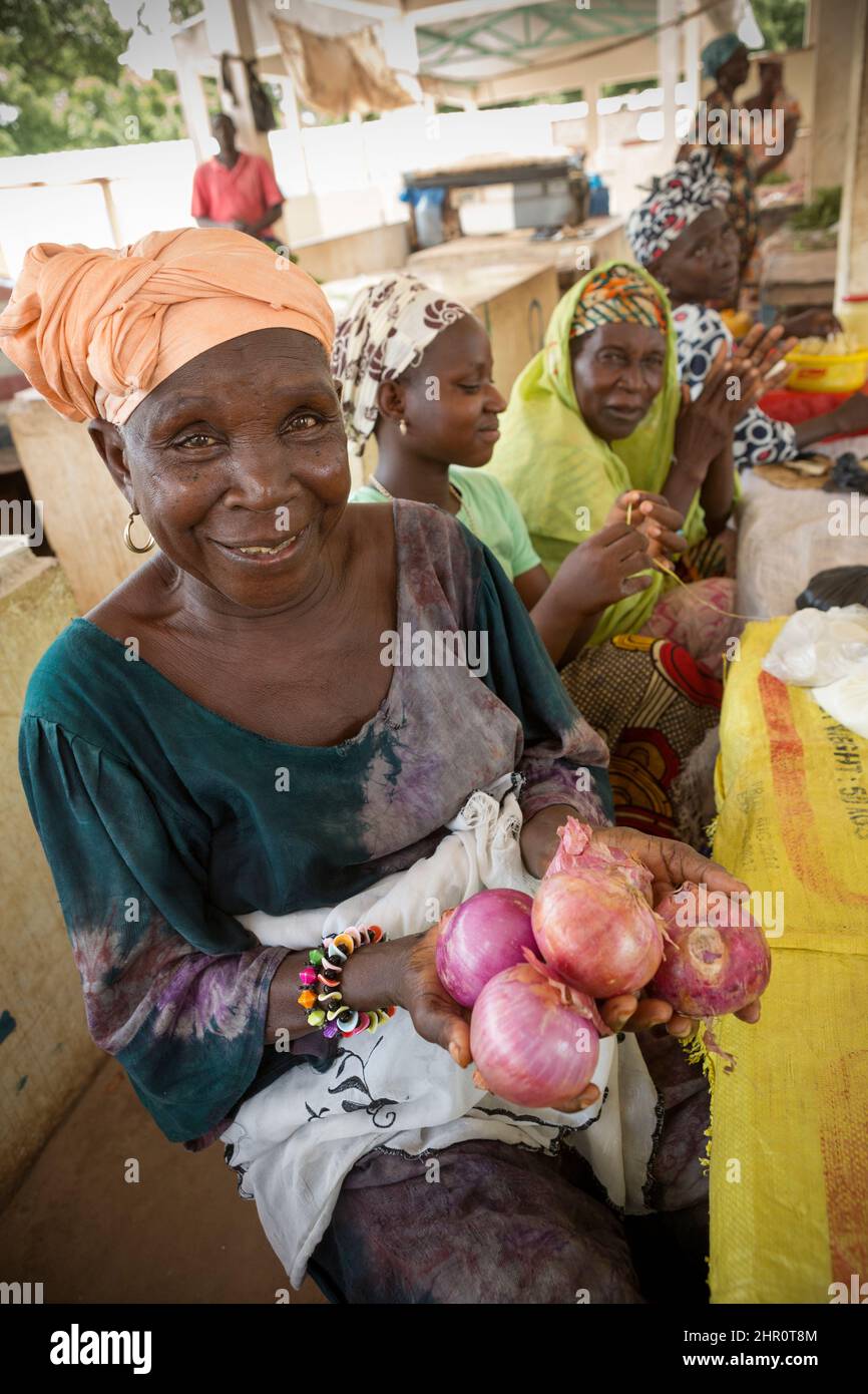 An African woman sells produce at her market stall in Tanaff, Senegal ...