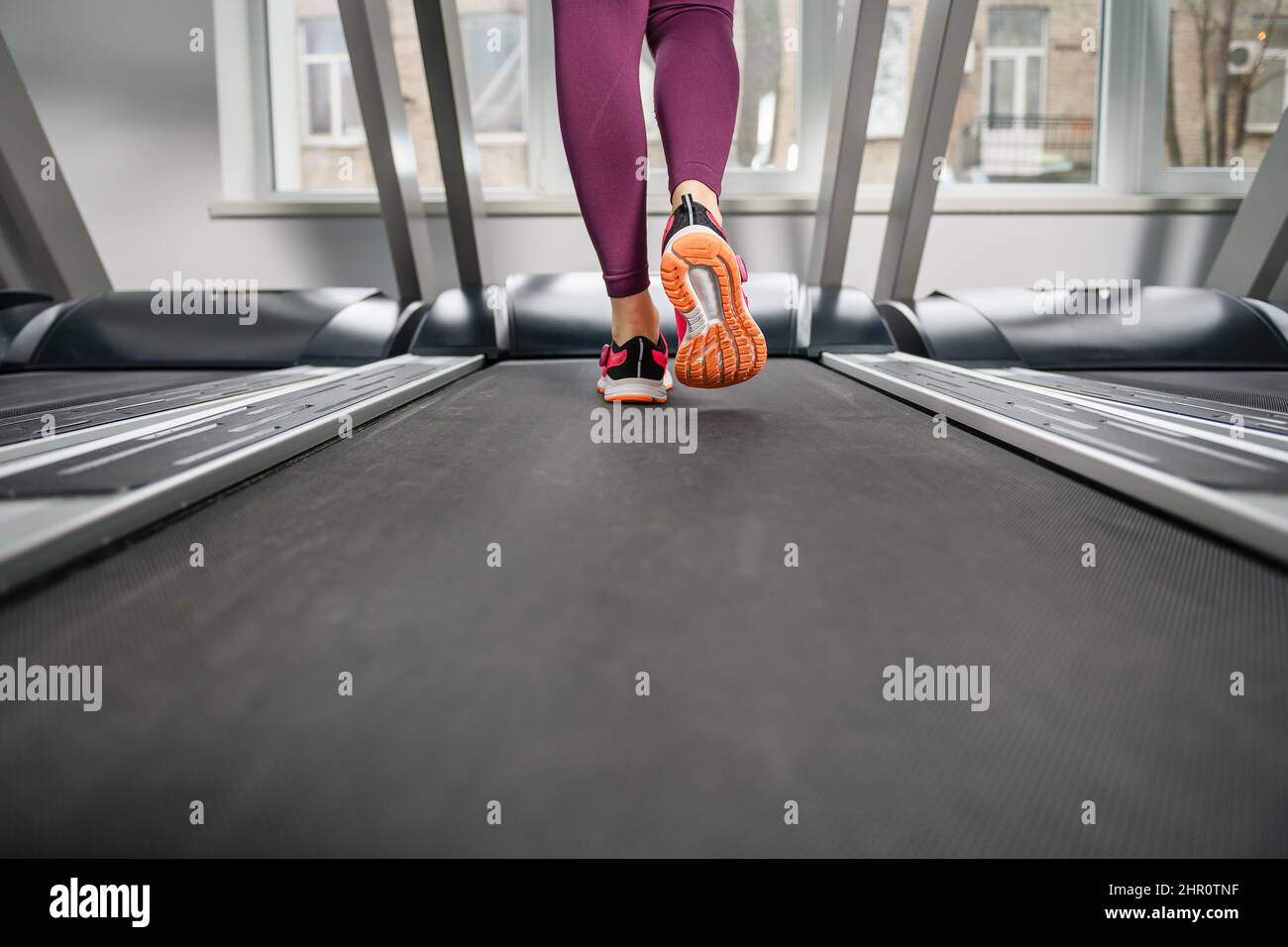 Bright sneakers soil of running sportive fit woman at treadmill track ...