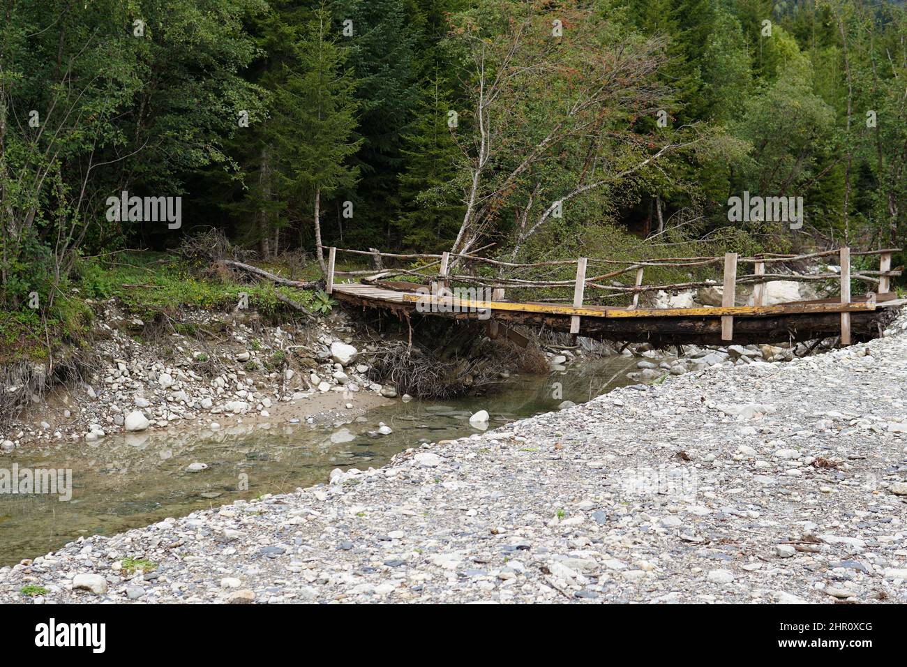 Small mountain river rushing along the stone bottom, rocky shore ...