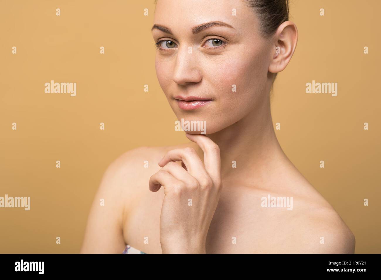 Happy caucasian girl with beautiful face touching healthy facial skin ...