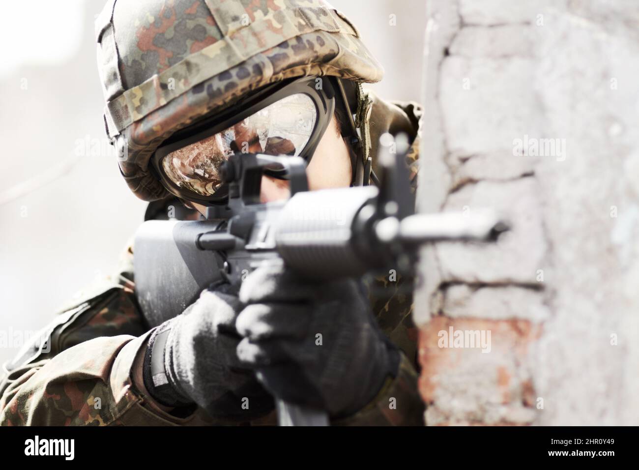 Hes a sharp shooter. Closeup of a soldier pointing his gun at the ...