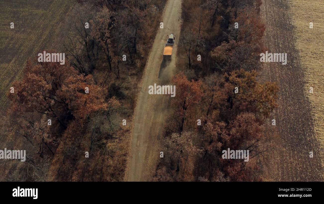 Aerial Drone View Flight Over Blue Tractor With Trailer Filled Yellow ...