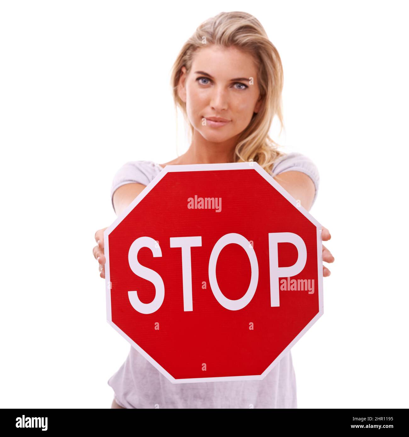 Heed the warning. A young blonde woman holding a stop sign Stock Photo ...
