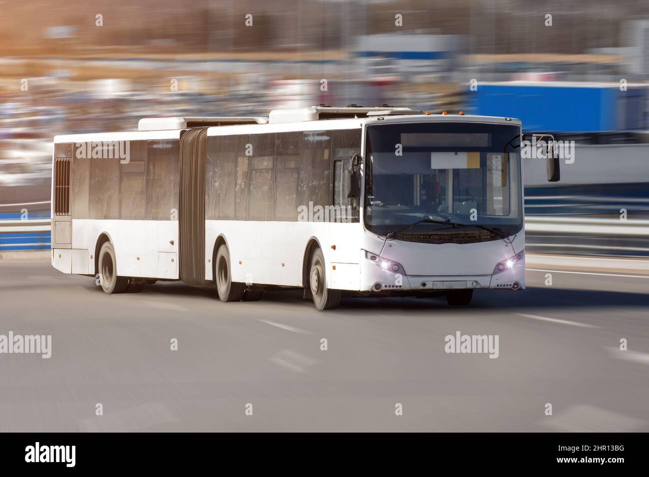 Passenger lengthened articulated bus city bus of white color rides at ...