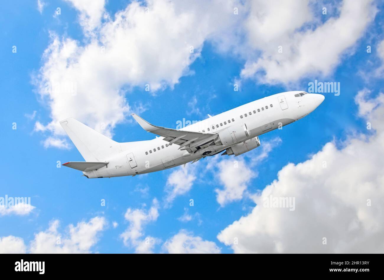 Passenger airplane fly on a hight above overcast clouds and blue sky ...