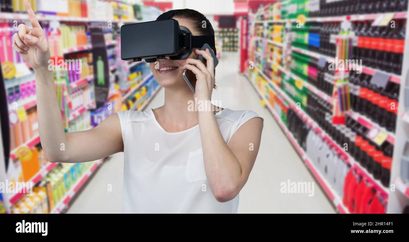 Composite image of caucasian wearing vr headset and talking on ...
