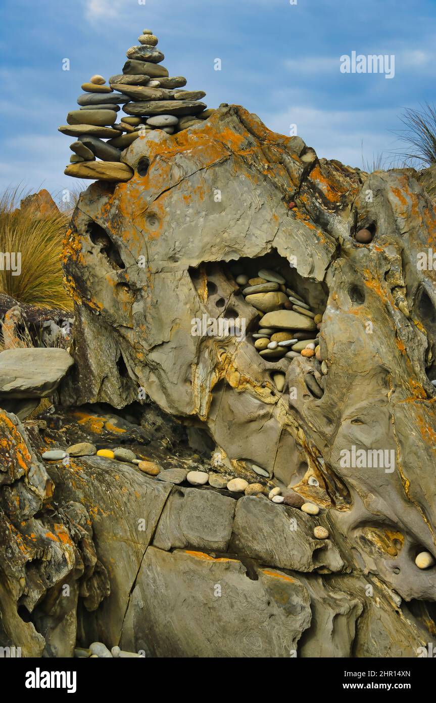 Amazing and fragile land art with smooth stones and pebbles on a rock ...