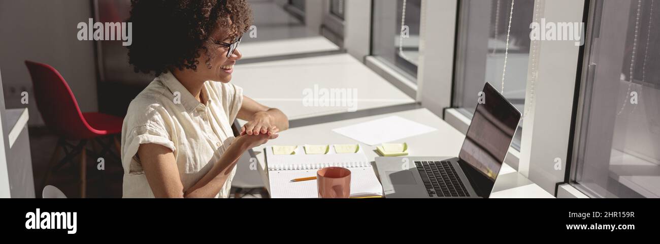 Happy lady communicating in sign language online at a laptop Stock ...