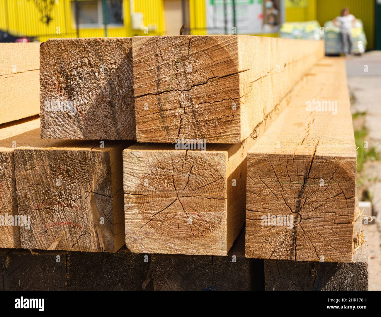a stack of wooden balks, wooden balks, beams at a sawmill, a warehouse ...