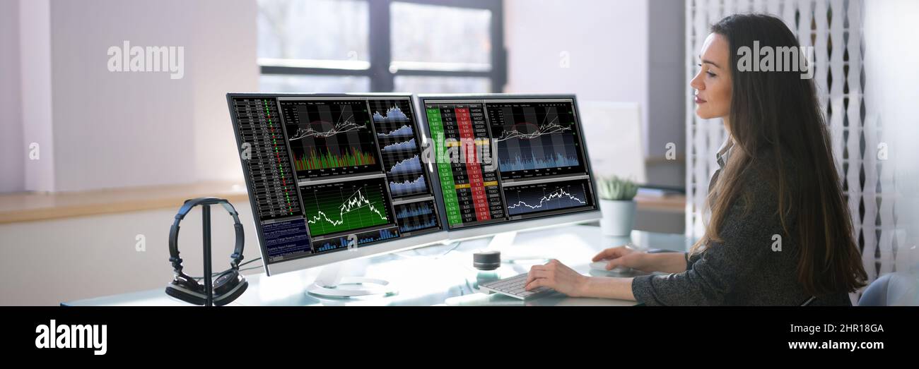 Analyst Using Multiple Computer Screens For Stock Trading Stock Photo ...