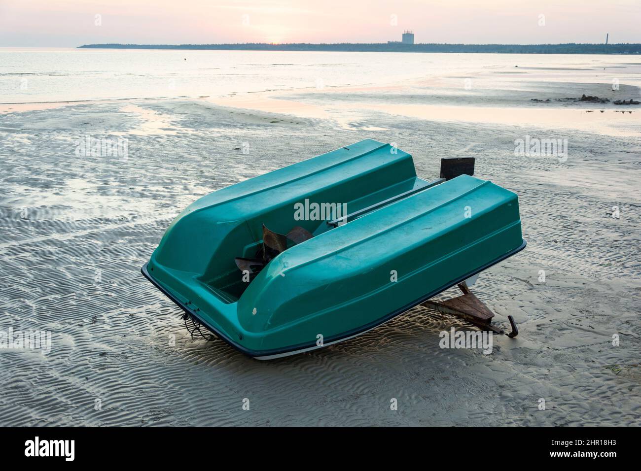 an old plastic inverted boat on the shore of the sea bay, an old ...