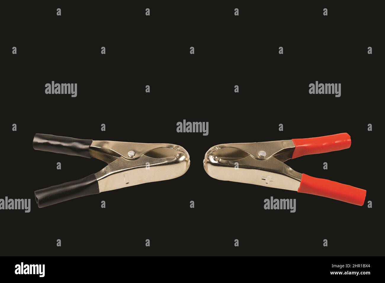Close up view of clips for charging battery isolated on black ...