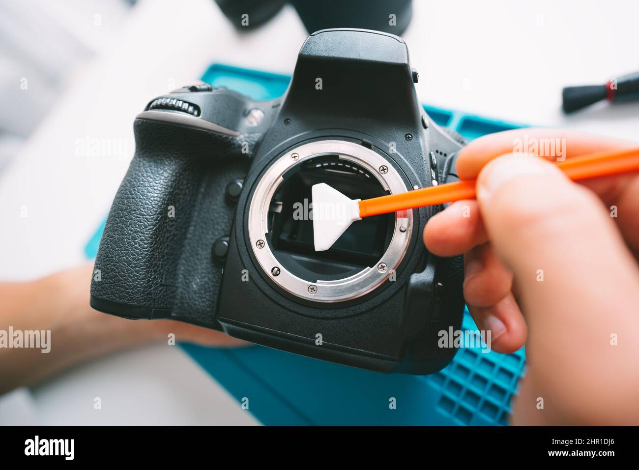 Man cleaning camera sensor with camera sensor cleaner or cleaning swab ...