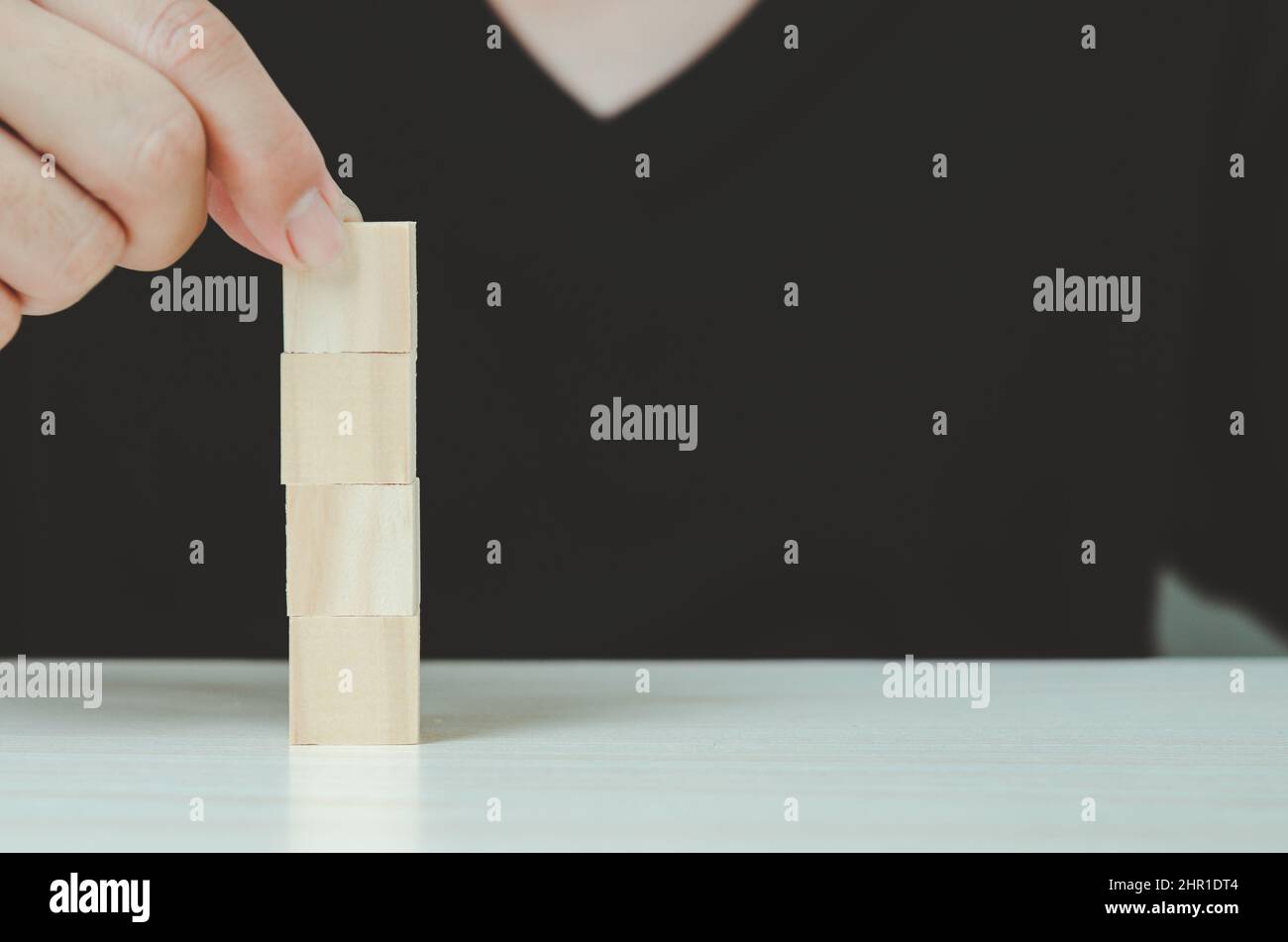 Hand putting and stacking blank wooden cubes for icons or symbols Stock ...