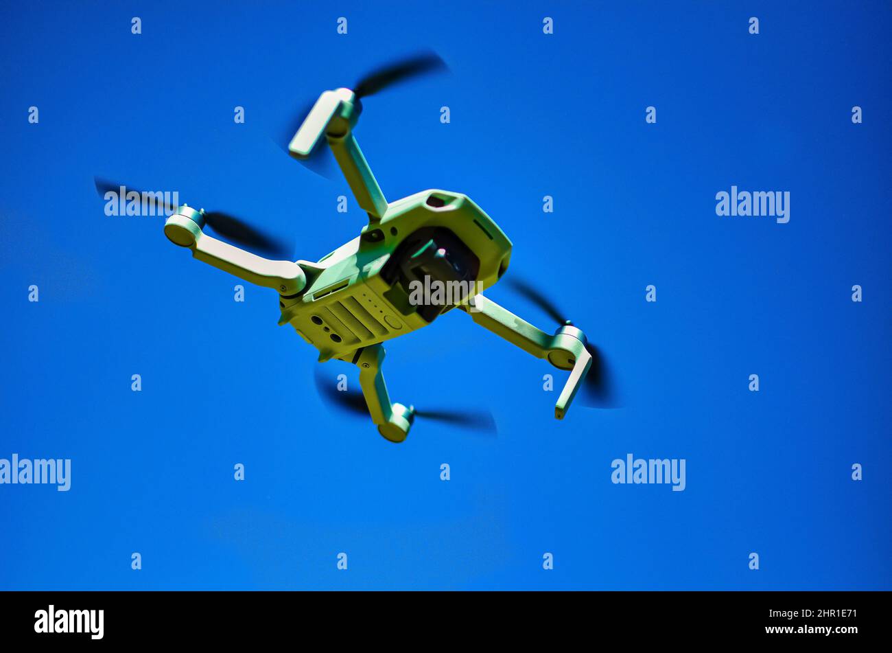 Drone flying overhead in cloudy blue sky Stock Photo - Alamy