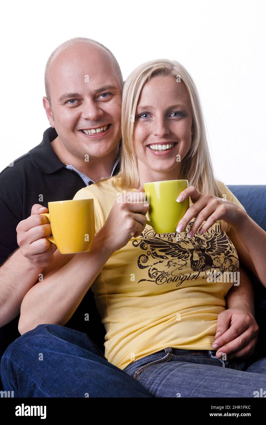 couple in love drinking a tea together on the sofa Stock Photo - Alamy