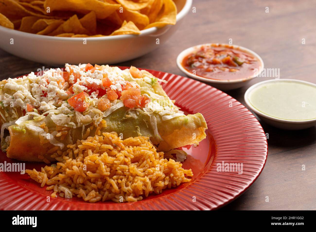A Pair of Mexicana Enchiladas with Seasoned Rice Stock Photo - Alamy
