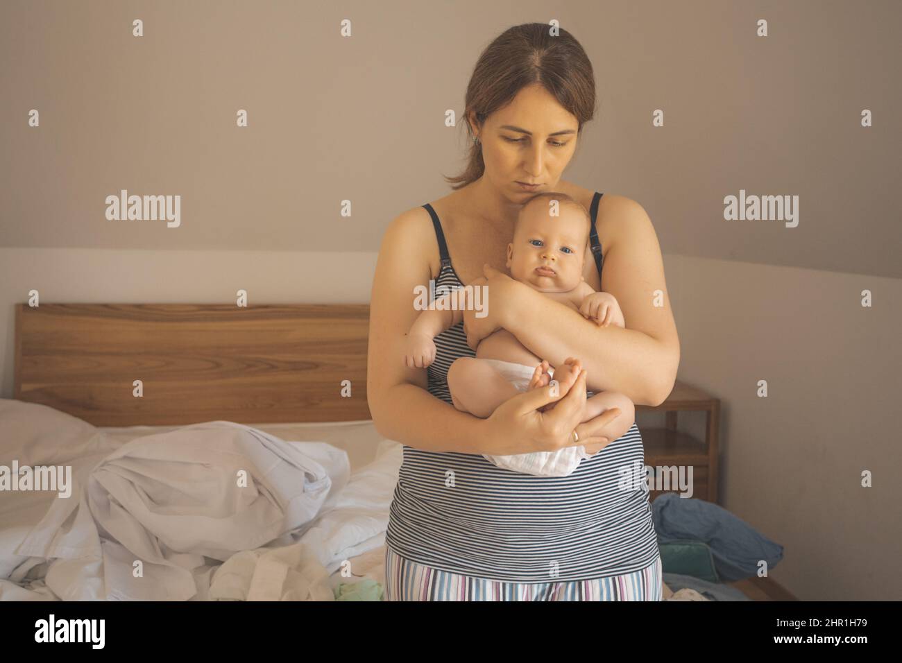 Beautiful young mother holding her son in her arms Stock Photo - Alamy