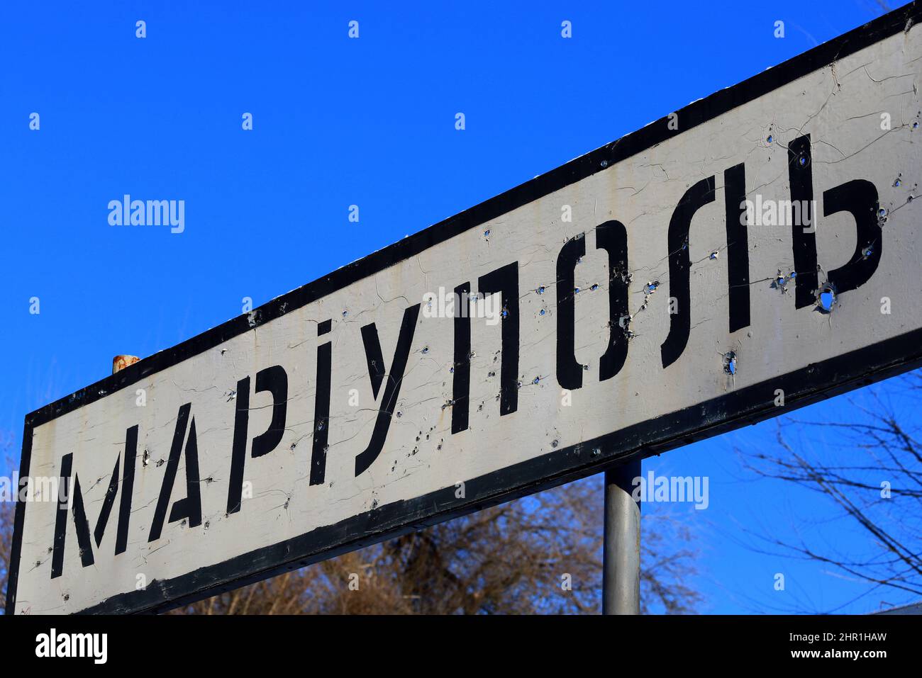 Road sign of Ukrainian city Mariupol, Donetsk region, punched by ...