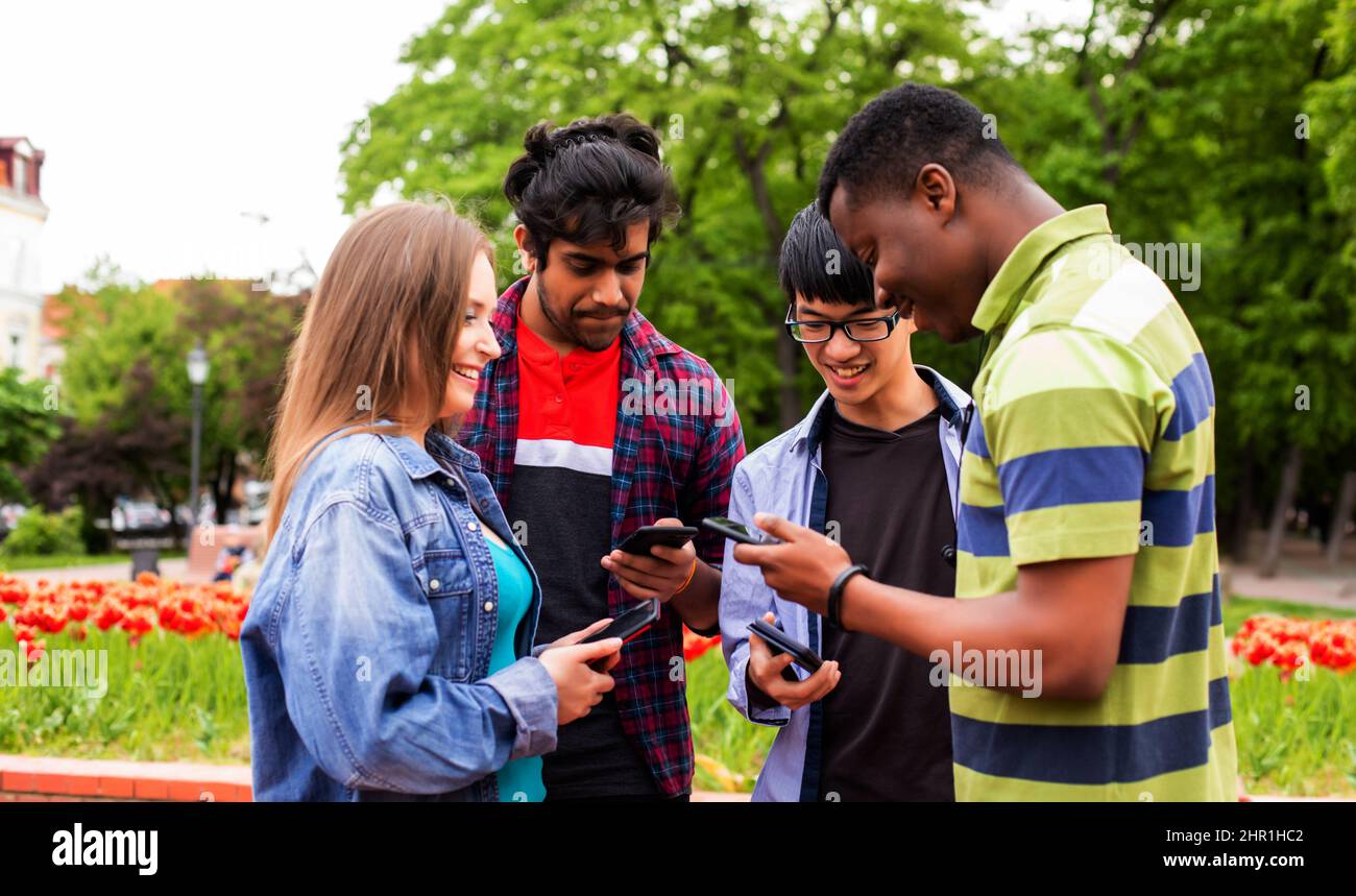 Multiethnic university students checking information using mobile ...