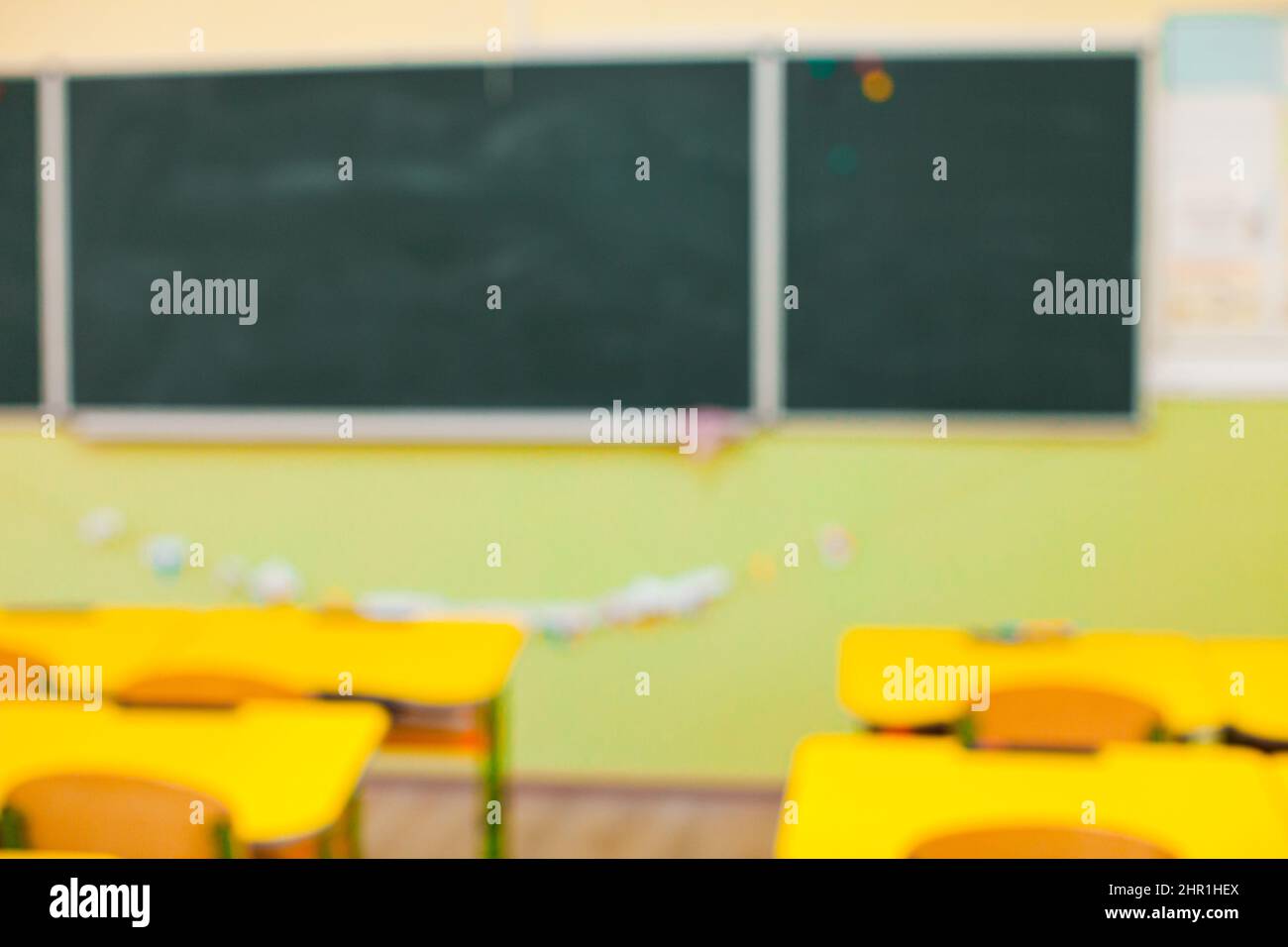 Blurred view of school classroom without young student Stock Photo - Alamy