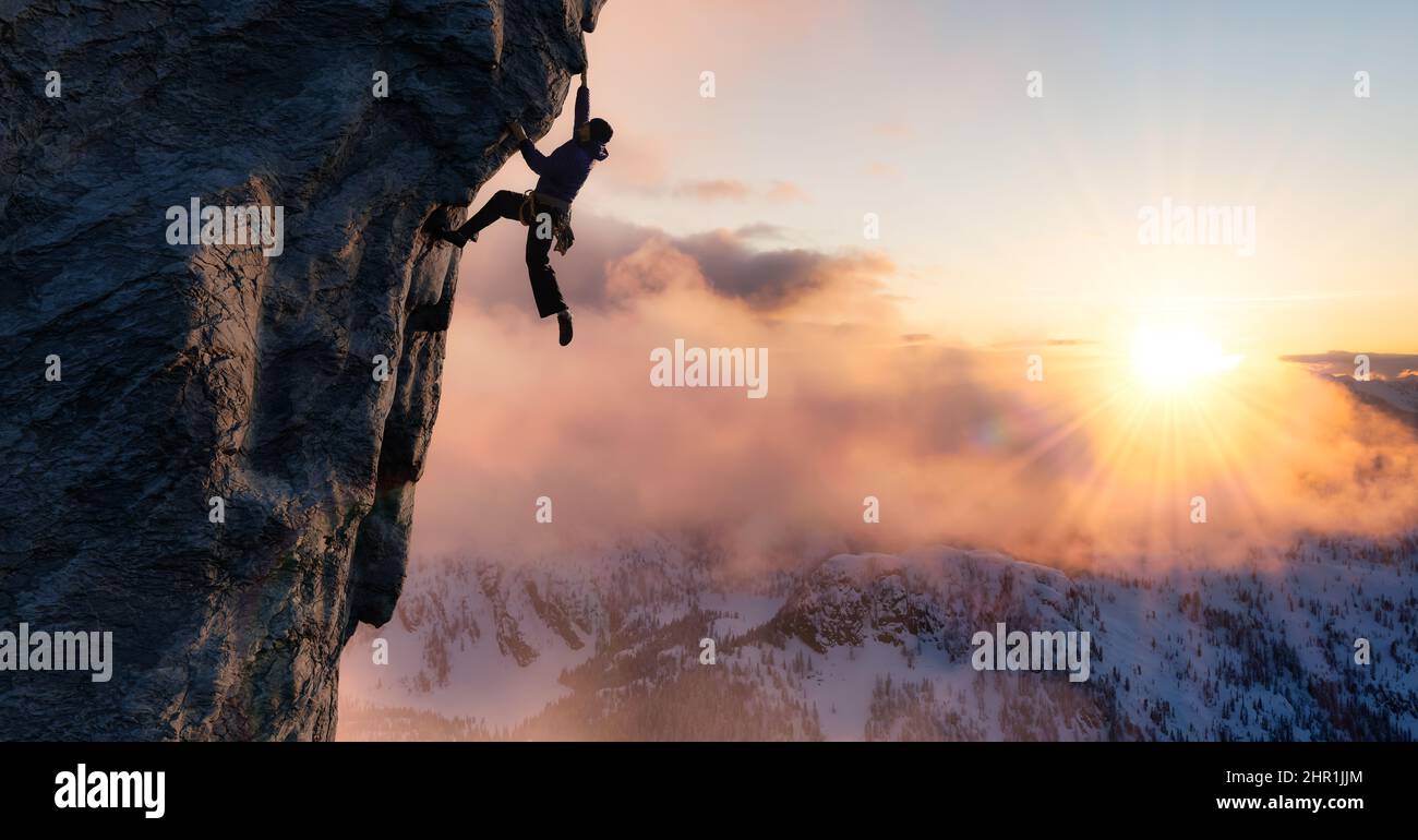 Adult adventurous man Rock Climbing a steep rocky cliff Stock Photo - Alamy