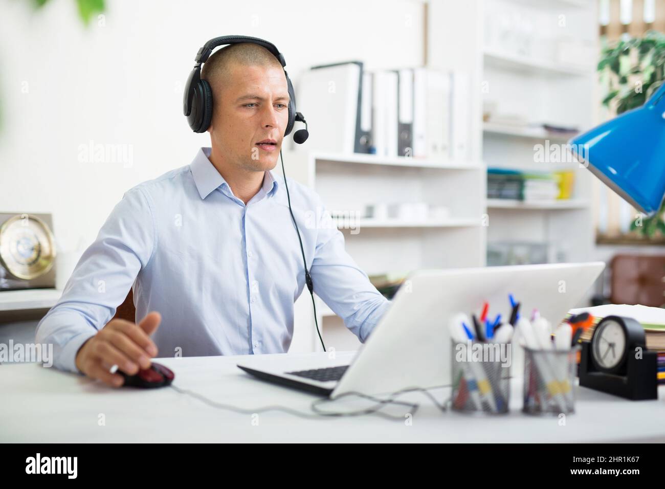 Call center man operator with headset talking with client Stock Photo ...