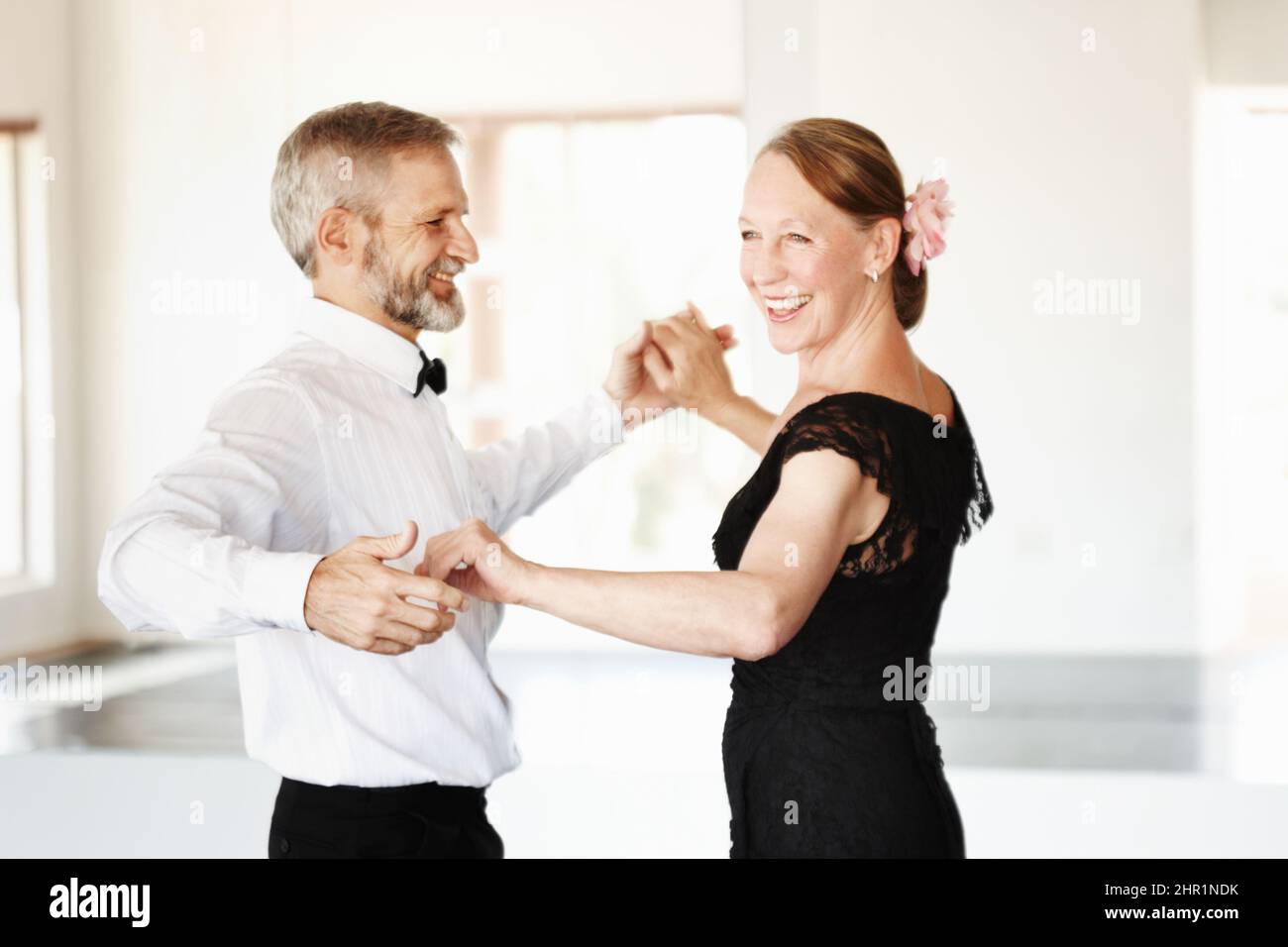 Still young at heart. Shot of a mature couple dancing together in ...