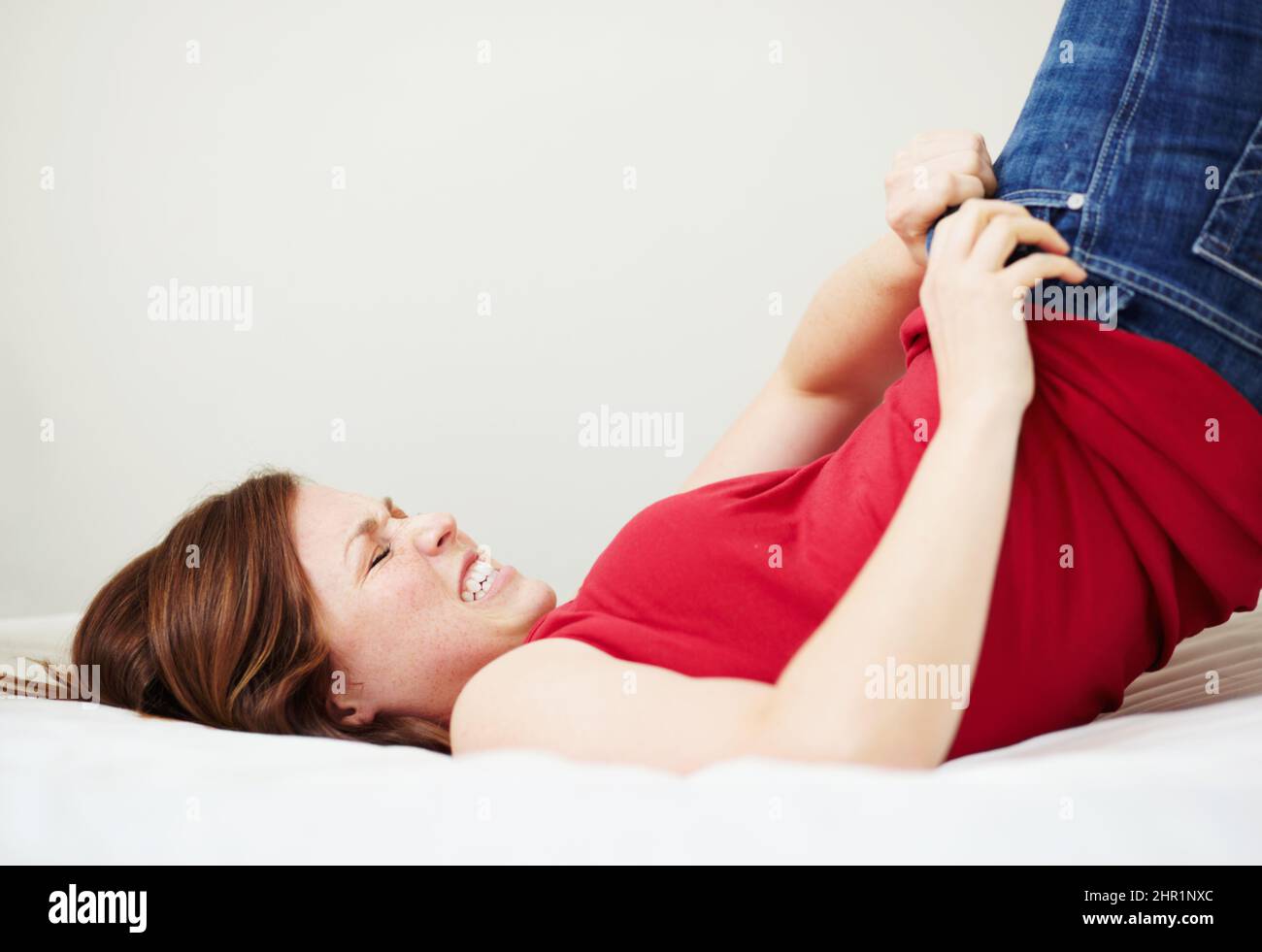 I need to drop a jeans size. A young woman trying to fit into her jeans ... I need to drop a jeans size. A young woman trying to fit into her jeans ...