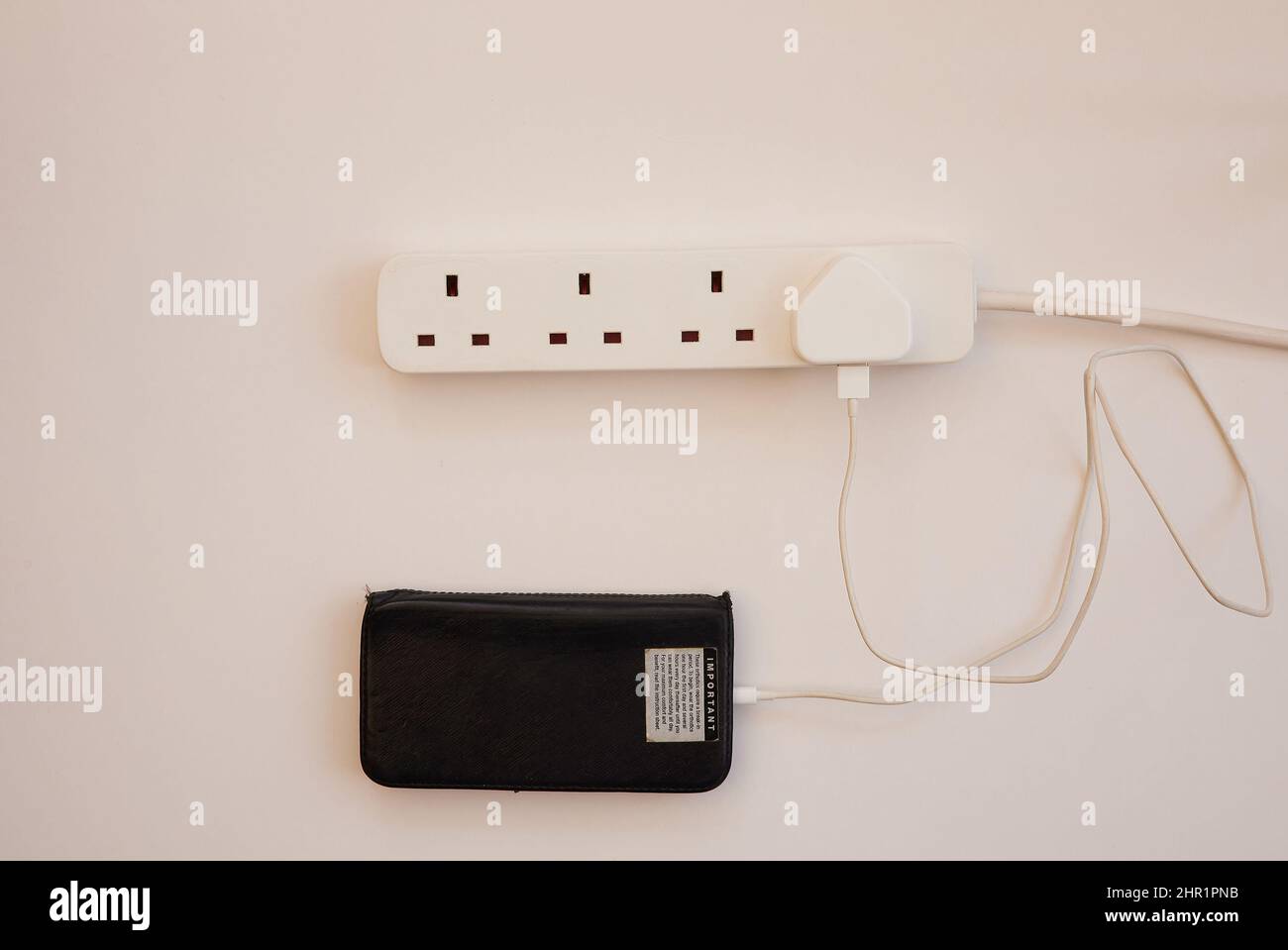 Mobile phone seen charging and connected to a multiple socket Stock ...