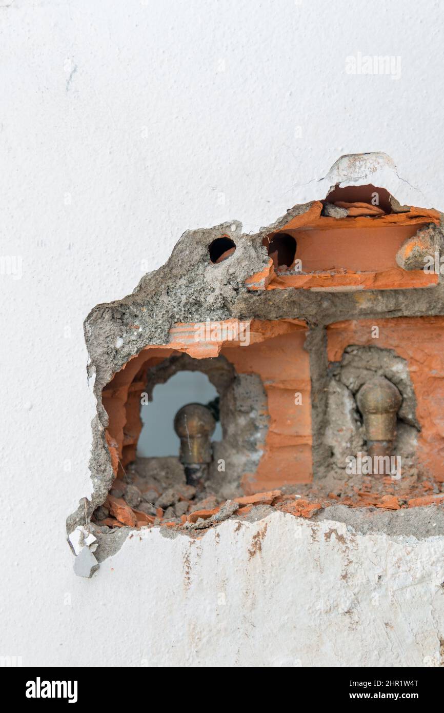 broken white wall with exposed bricks in a building in Rio de Janeiro ...