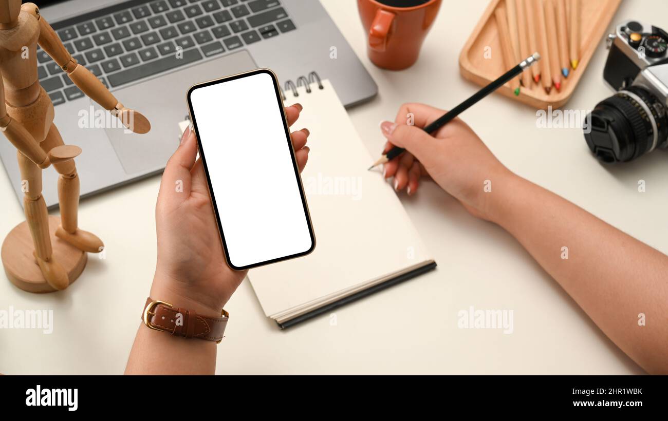 Close-up, Woman hands noting something on spiral notepad and using ...