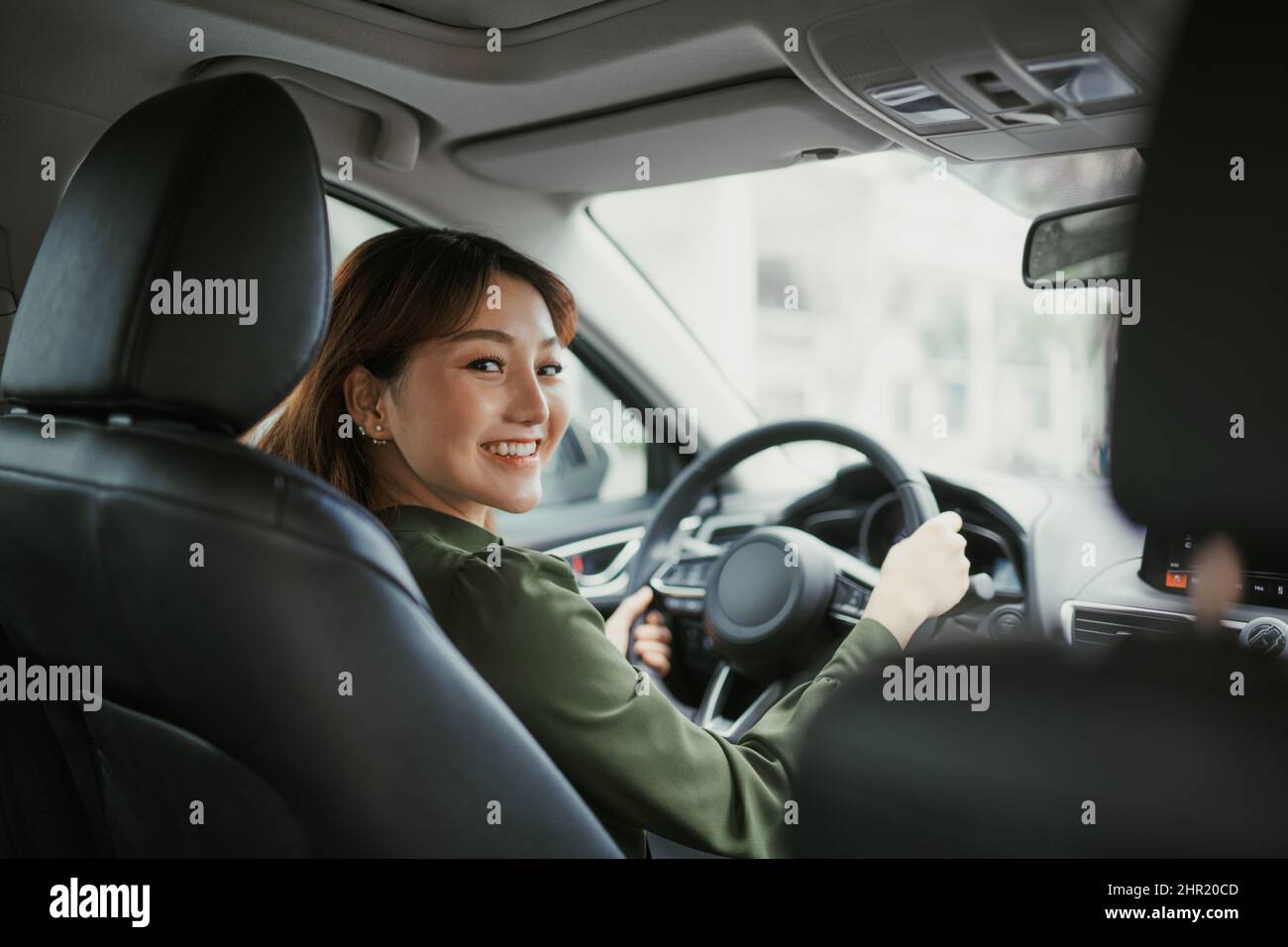 Asian women driving a car and smile happily with glad positive ...