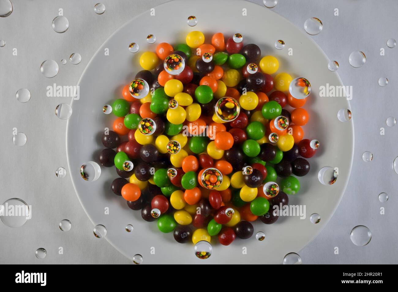 Water drops on Candy Bowl Background Stock Photo - Alamy