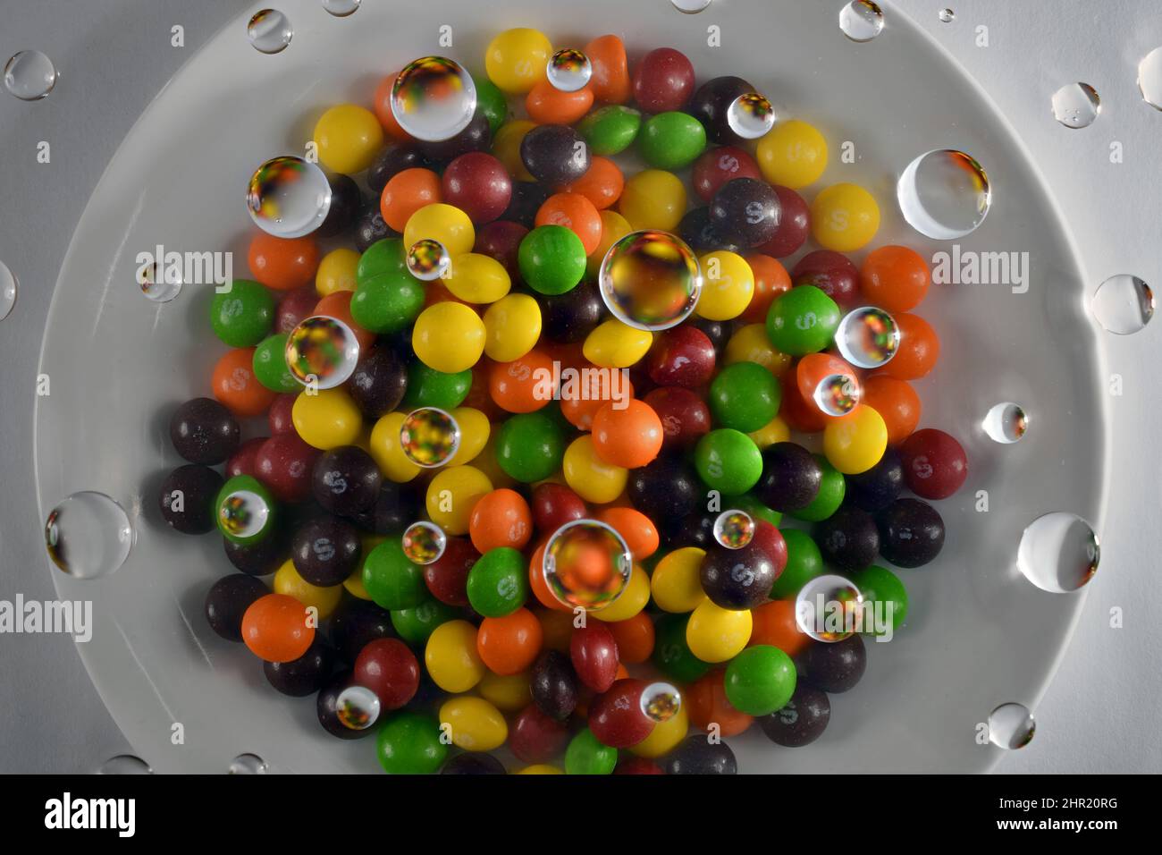 Water drops on Candy Bowl Background Stock Photo - Alamy